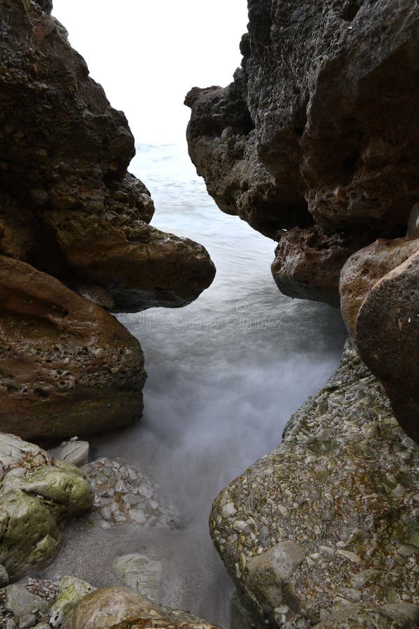 Vertical Shot of a Waterscape between a Crack in Rocky Cliffs Stock ...