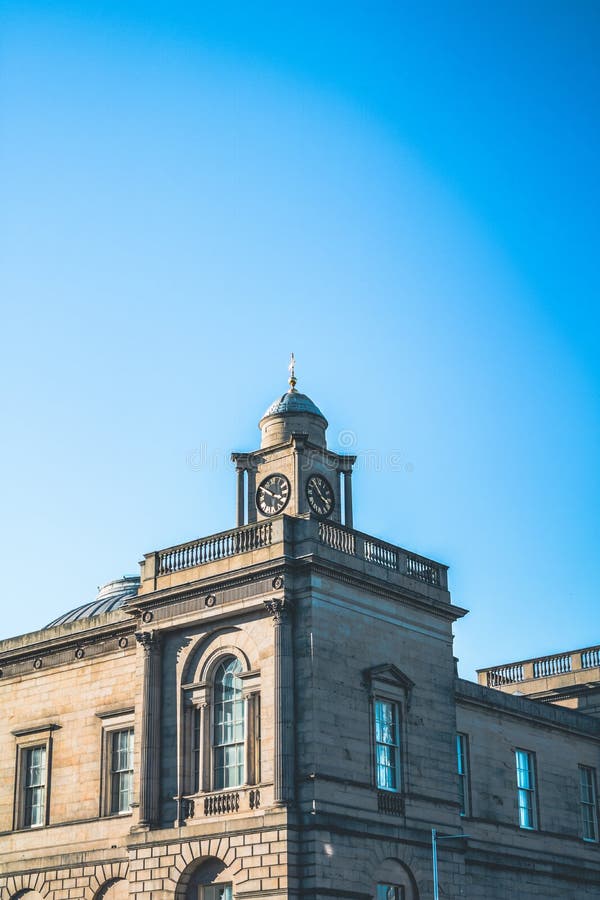 Vertical Shot of a White Building with a Clock Under a Blue Sky Stock ...