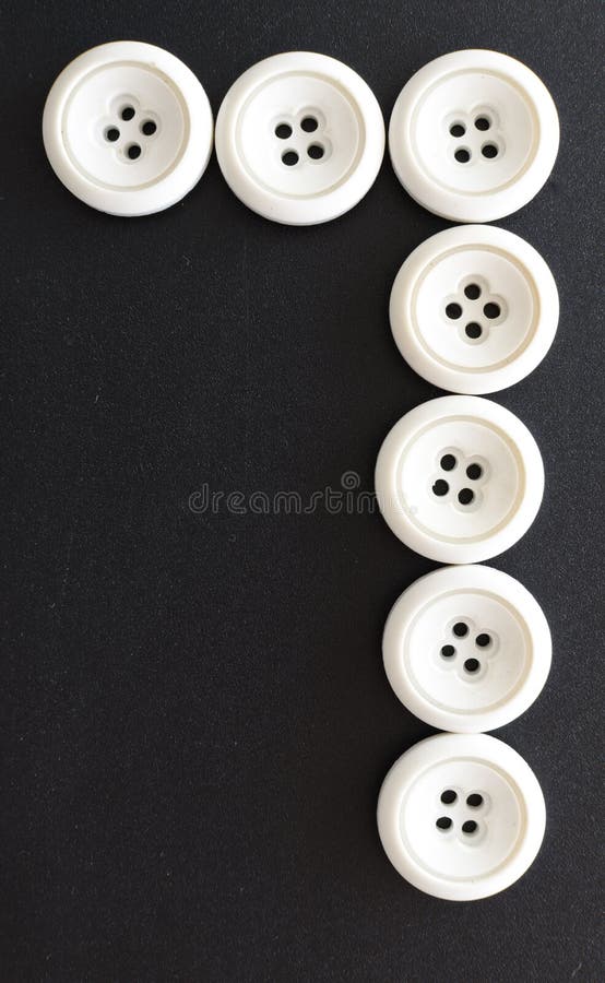 Vertical Shot of White Buttons Assorted Like the Number Seven on a ...