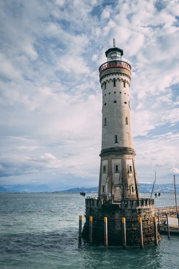 Vertical Shot of a White Lighthouse in the Sea Under the Beautiful ...