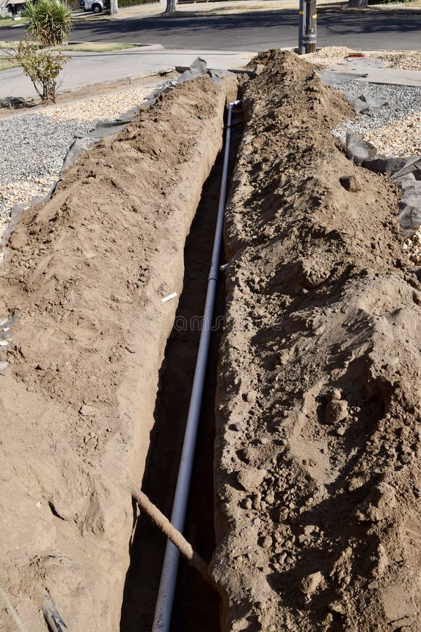 Vertical Shot of a White Pipeline Going through the Ground Stock Photo ...