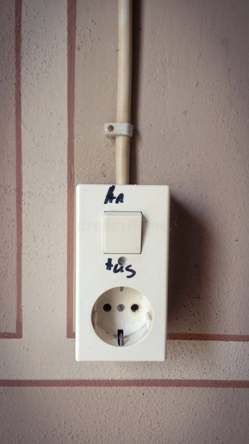 Vertical Shot of a White Plug Socket with External Wire Over an Old ...