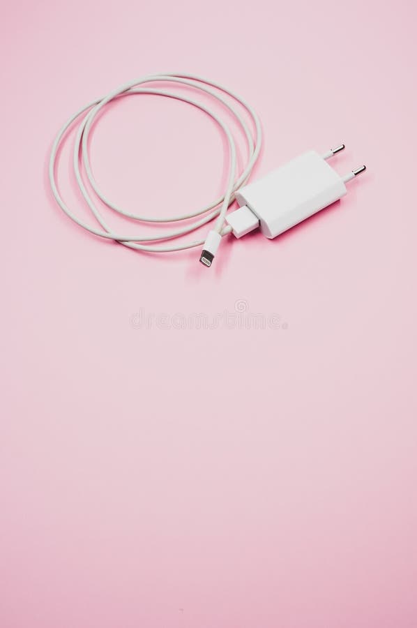 Vertical Shot of a White Smartphone Charger on a Pink Surface Stock ...