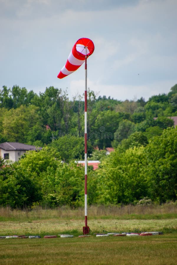 Vertical Shot of a Wind Indicator with Greenery in the Background Stock ...