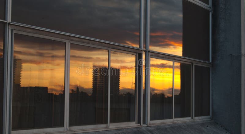 Vertical Shot of Windows with Reflection of the Sunset in it Stock ...