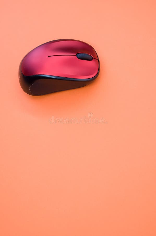 Vertical Shot of a Wireless Mouse on an Orange Surface Stock Photo ...