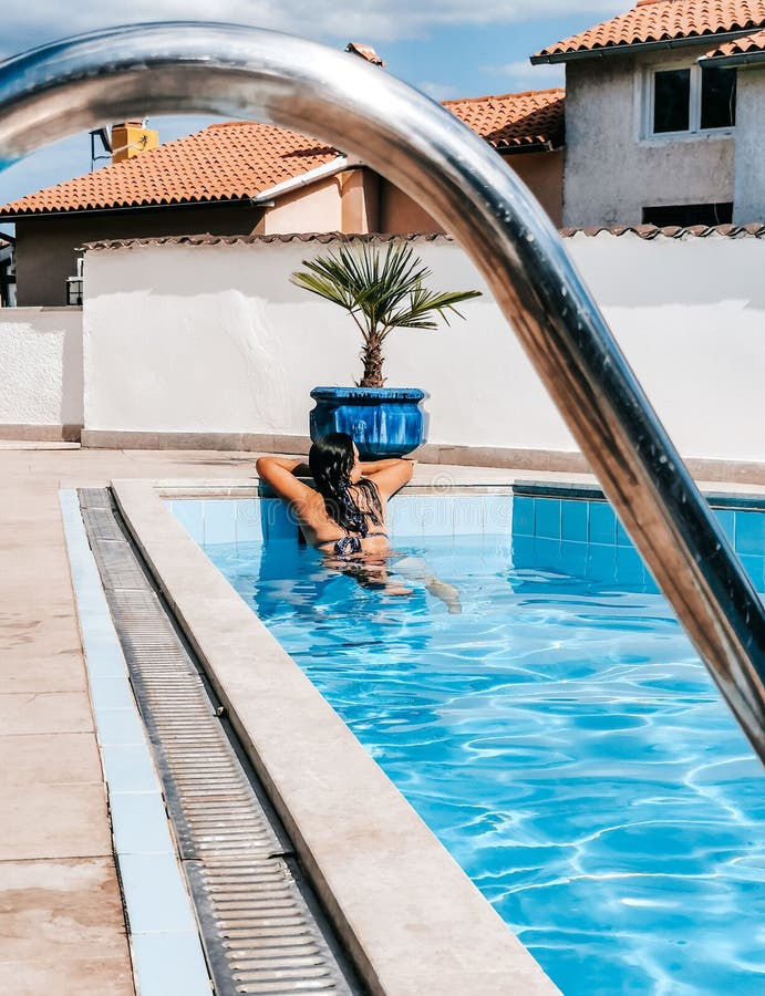 Vertical Shot of a Woman by the Side of the Pool Stock Image - Image of ...