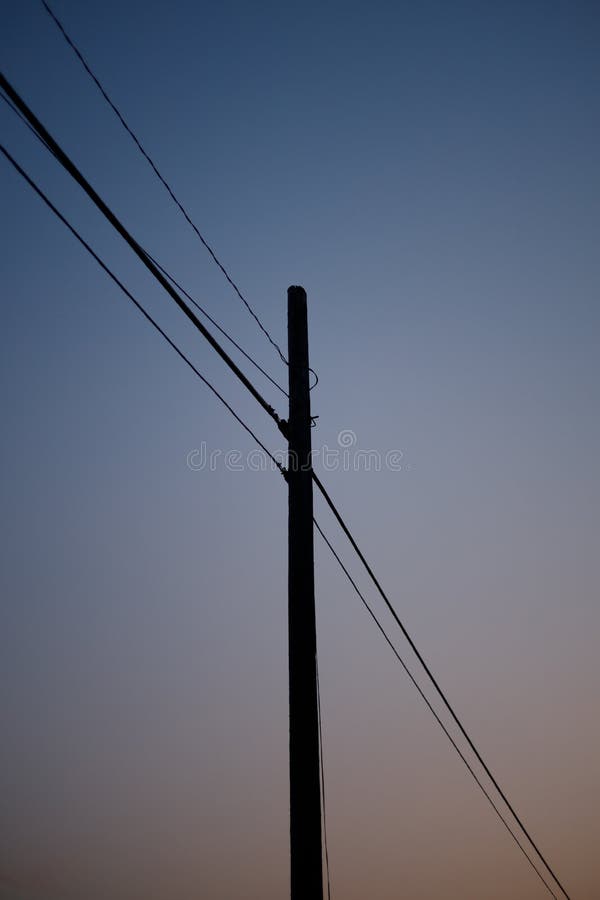 Vertical Shot of a Wooden Electrical Pole in a Sunset Sky Stock Image ...