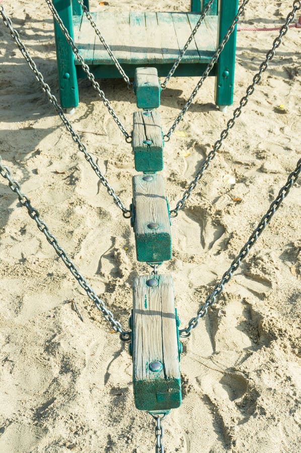 Vertical Shot of a Wooden Green Obstacles Row Hanging on Chains at a ...