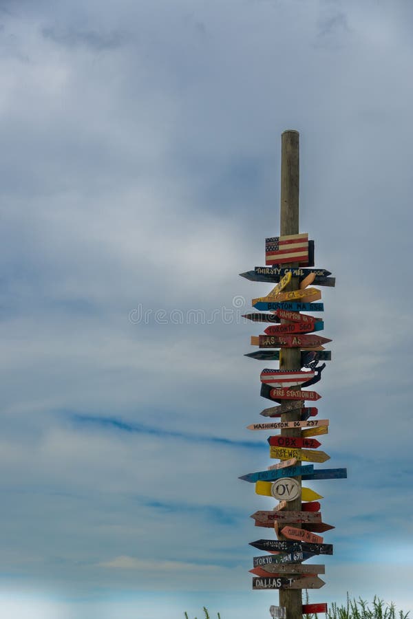 Vertical Shot of a Wooden Pole with Directions Stock Photo - Image of ...
