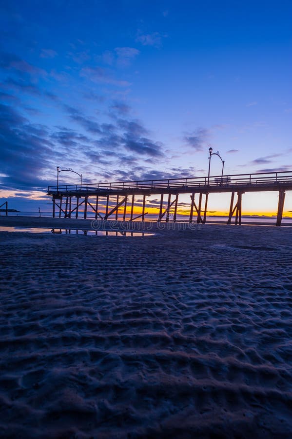 Vertical Shot of a Wooden Port Over the Shore at Sunset Stock Photo ...