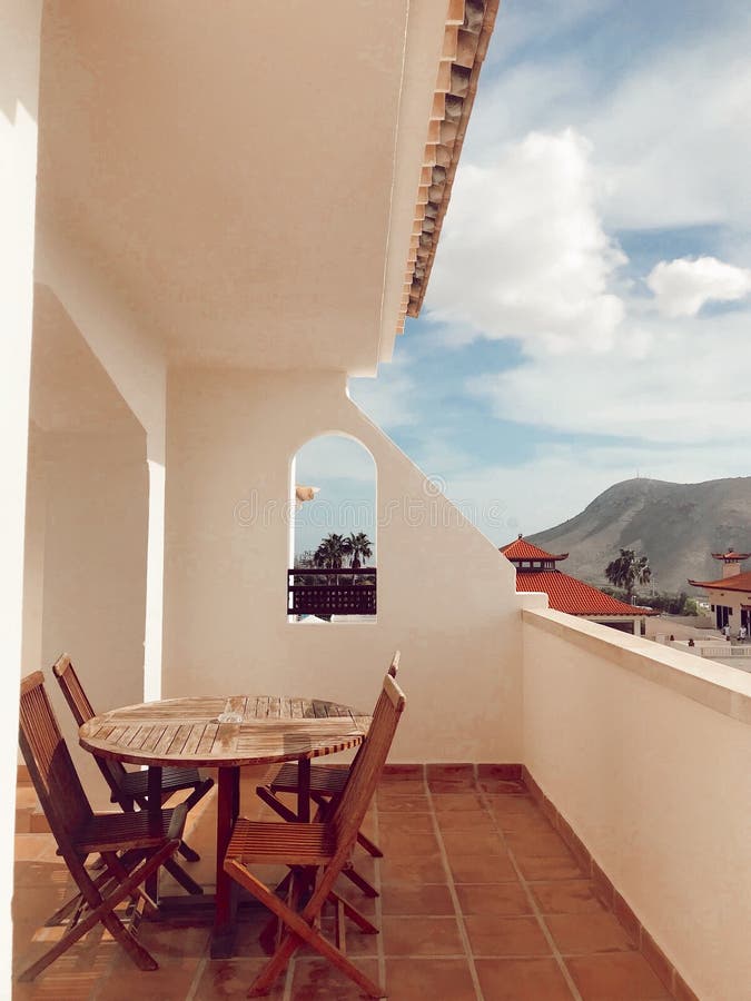 Vertical Shot of a Wooden Table with Chairs in the Balcony Stock Photo ...