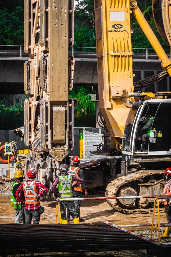Vertical Shot of Workers Working on a Construction Site Project ...