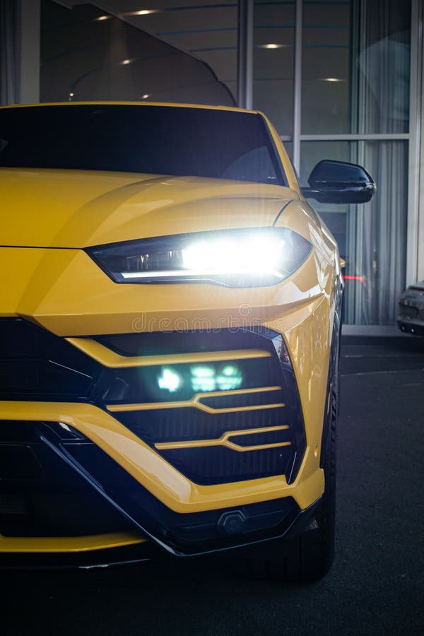 Vertical Shot of the Yellow Lamborghini Urus Front with Headlights on ...