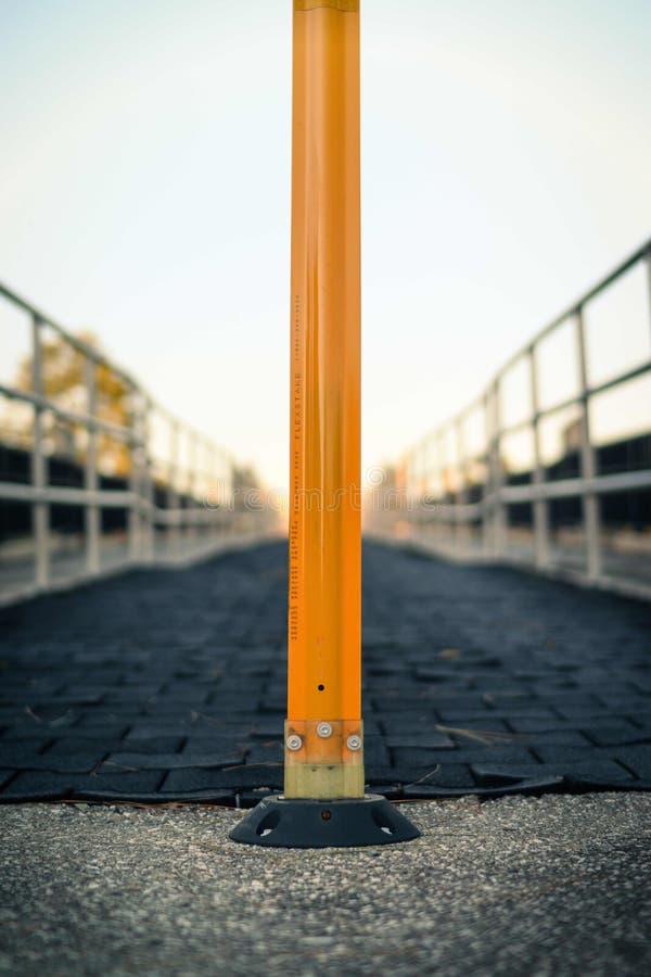 Vertical Shot of a Yellow Pole on the Ground Outdoors Stock Image ...