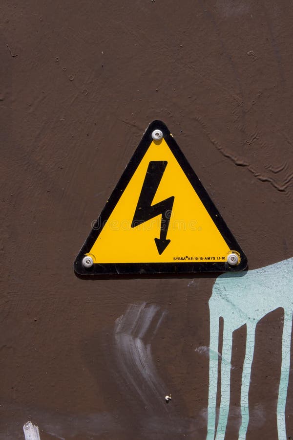 Vertical Shot of a Yellow Triangular Sign Warning of Dangerous ...