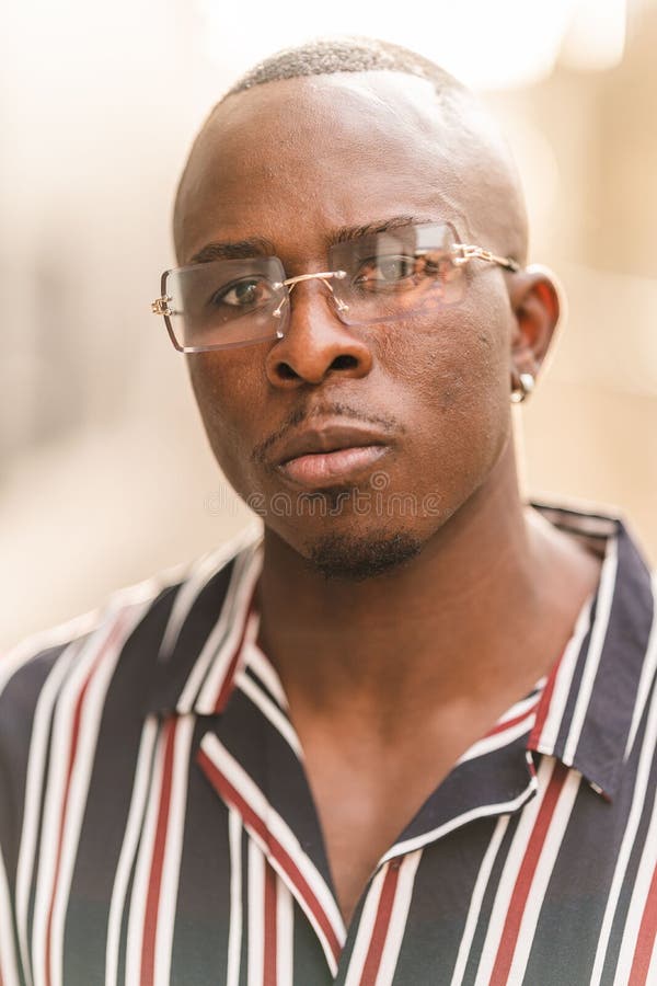 Vertical Shot Of A Young Attractive Black Male With A Striped Shirt And