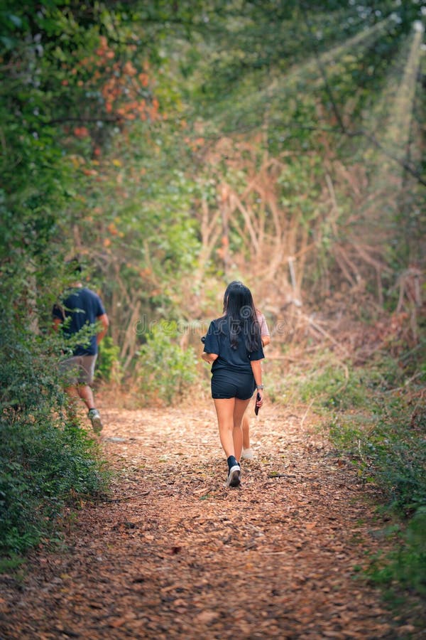 Vertical Shot of a Young Girl Walking in the Forest Stock Image - Image ...