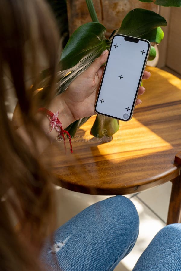 Vertical Shot of a Young Lady with a Phone in Her Hand with White ...