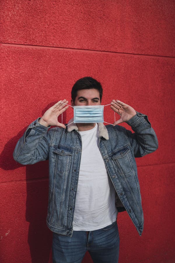Vertical Shot of a Young Man Wearing a Sanitary Mask Standing in Front ...