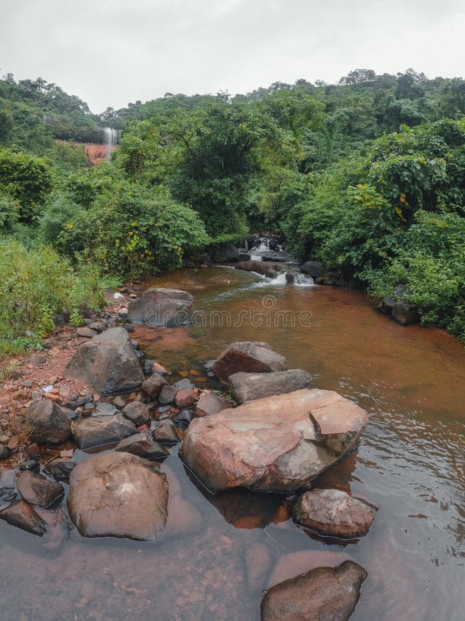 A Vertical Side Angle Photo of Small River Flowing Downside of a Hill ...