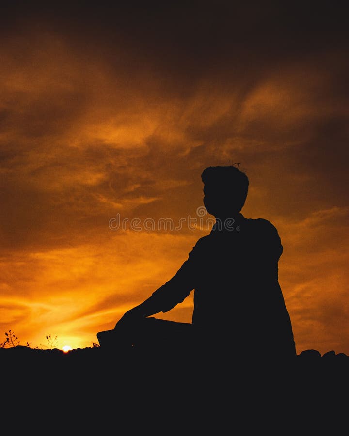 Vertical Silhouette of a Maditating Man at Sunset Stock Photo - Image ...