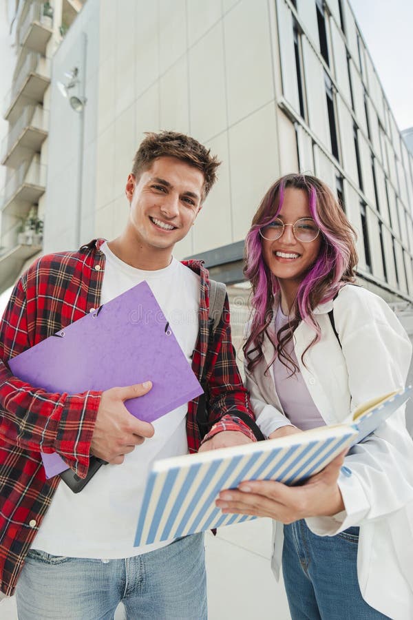 Vertical. Smiling Students Reviewing Notes Together Outdoors, Holding ...