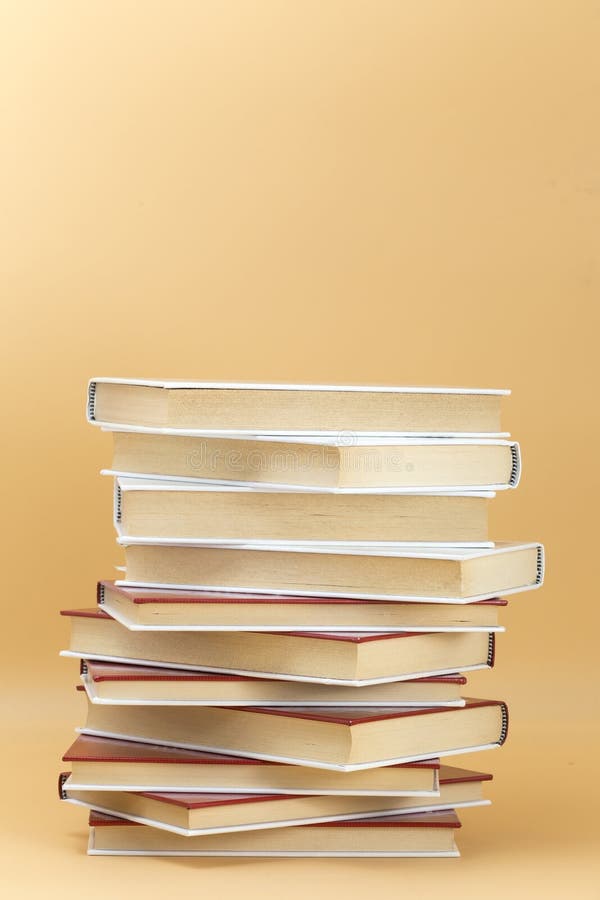 Vertical Stack of Books on an Orange Background Stock Image - Image of ...