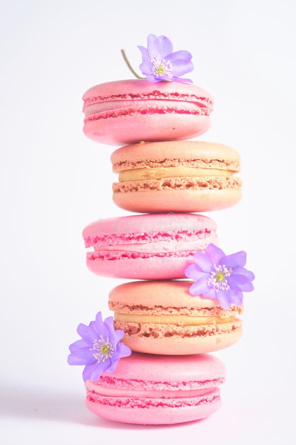 Vertical Stack of Macarons with Lilac Flowers on White Background Stock ...