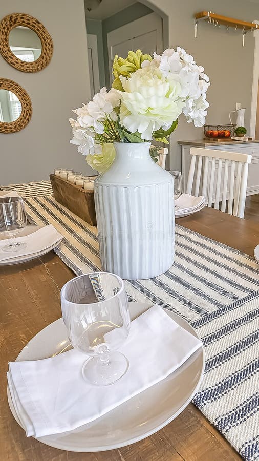 Vertical Table Setting Inside a Dining Room with Brown Table and White ...