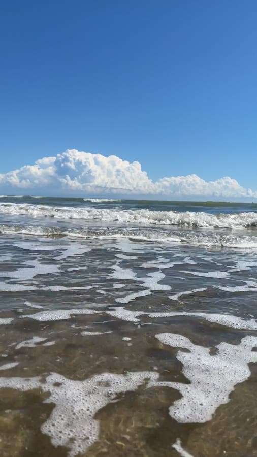 Vertical Time-lapse Shot of Waves in the Sea with Clear Blue Sky in the ...