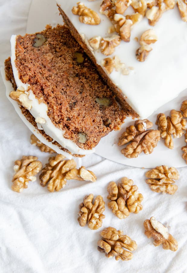 Vertical Top View of a Cake with White Icing and Walnuts on a White ...
