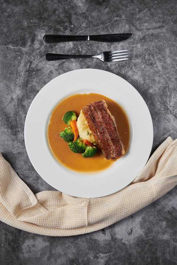 Vertical Top View of Cooked Meat with Vegetables and Sauce Served on a ...