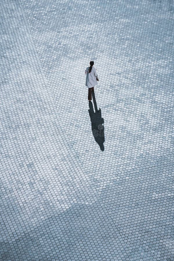Vertical Top View of a Female Walking with Her Shadow on the ...