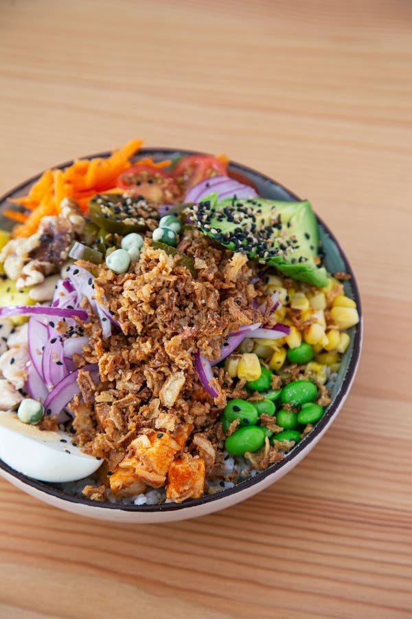 Vertical Top View of a Poke Bowl with Vegetables on a Wooden Table ...