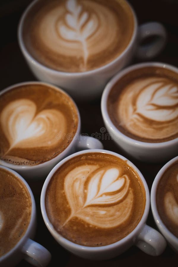 Vertical Top View of Several Cups of Latte with Different Patterns ...