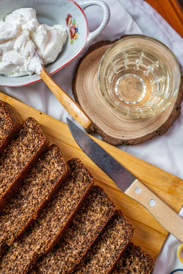 Vertical Top View of Sliced Walnut Bread, Sour Cream, and a Glass on ...