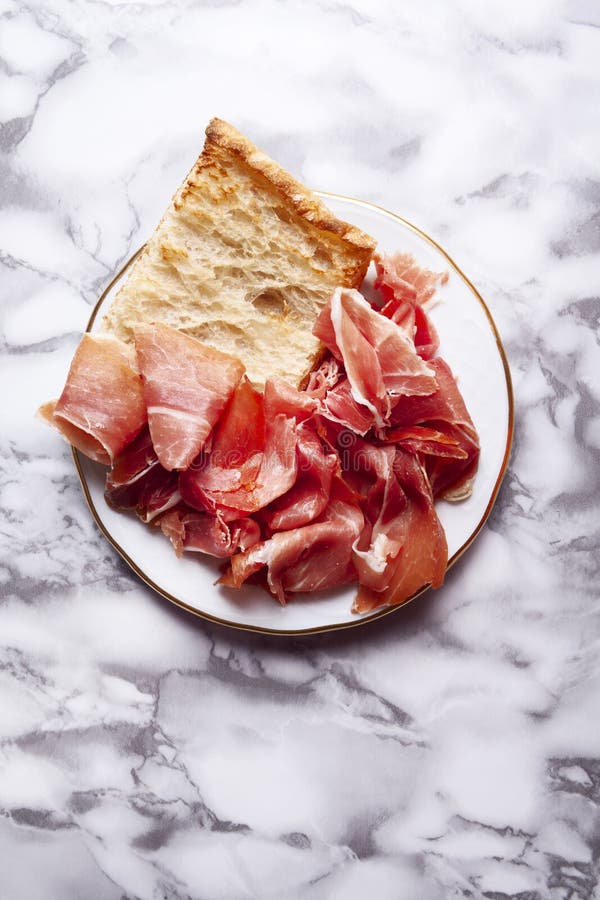 Vertical Top View of Smoked Ham Slices with Rustic Bread on a Marble ...