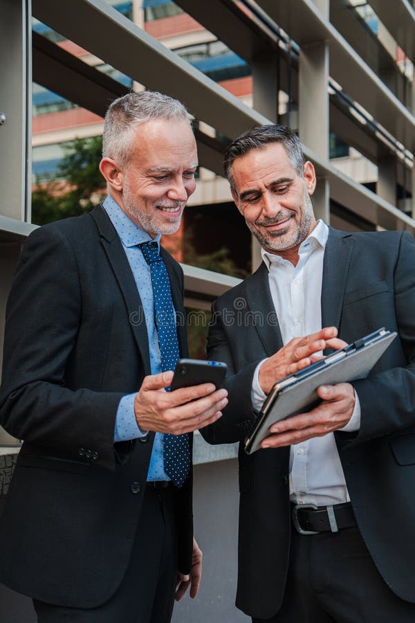 Vertical. Two Professional Colleagues Suited Up and Engrossed ...