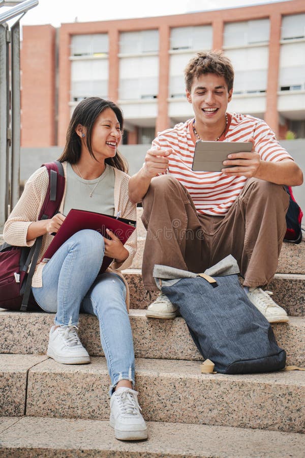 Vertical Two Teenagers Sitting on the University Campus Stairs ...