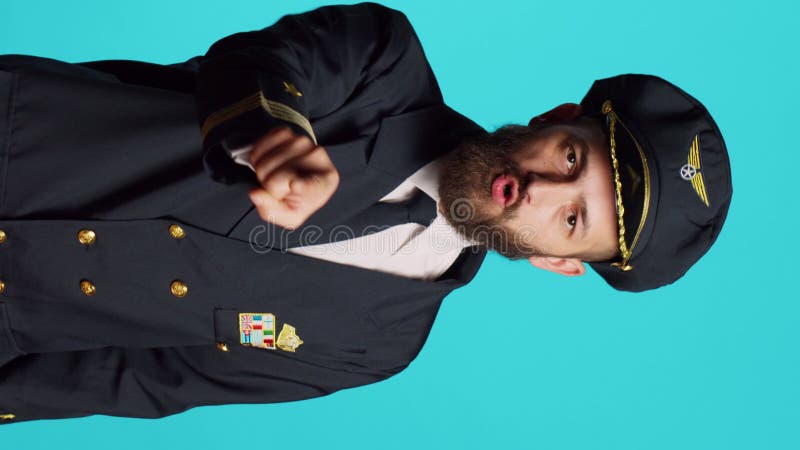 Vertical Video: Airplane Pilot in Uniform Pointing at Camera Stock ...