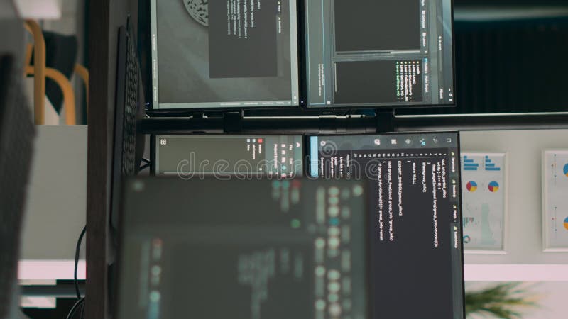 Vertical Video: Computer Screens on Desk in Empty Data Room Displaying Program Code and Stock ...