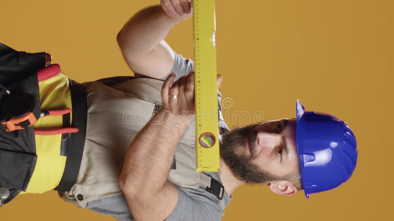 Construction Builder Working with Water Level Tool To Do Measurement ...