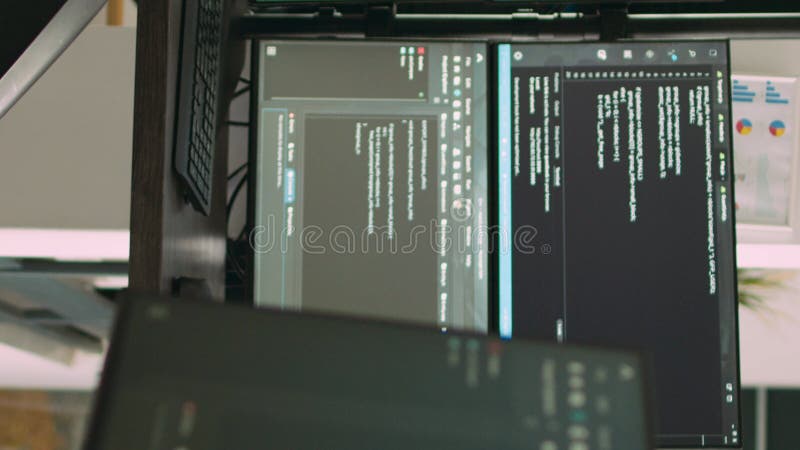 Vertical Video: Desk with Multiple Monitors Displaying Terminal Window and Artificial ...