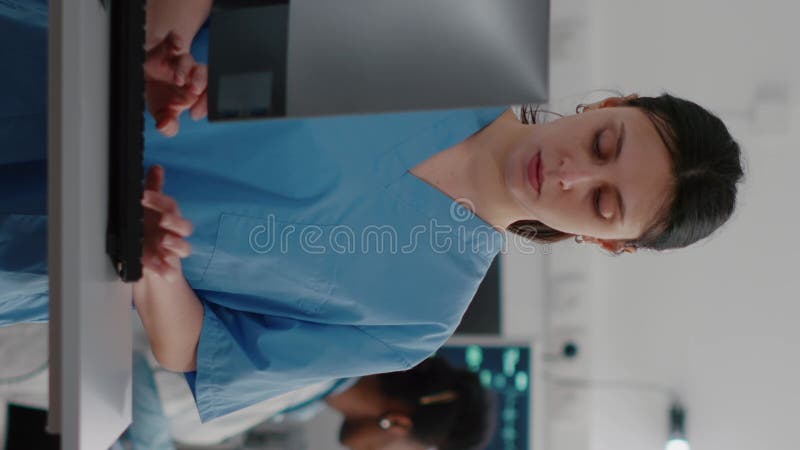 Vertical Video: Front View of Nurse Typing Medical Expertise on ...