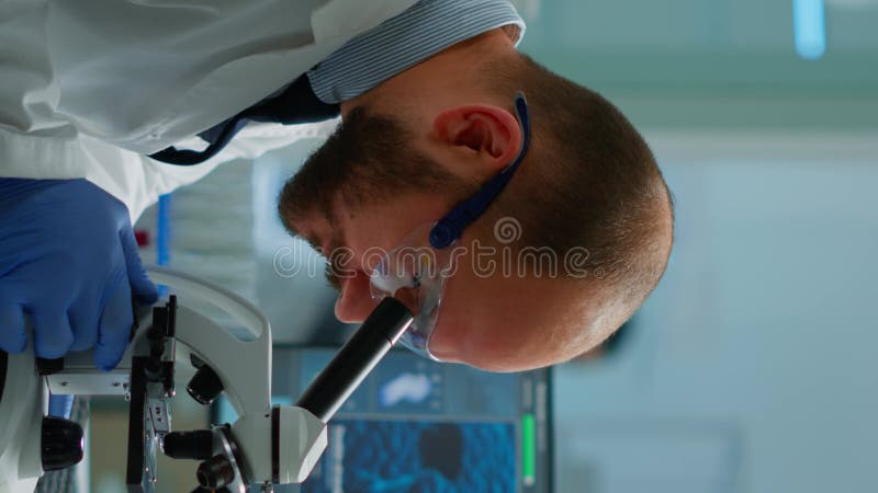 Laboratory with Old Male Scientist Observing Specimen Under Microscope ...