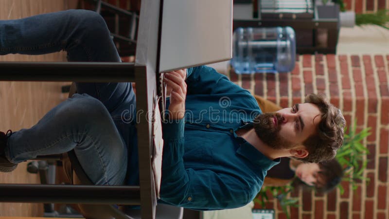 Vertical Video: Project Manager Using Laptop To Work on Business Report ...