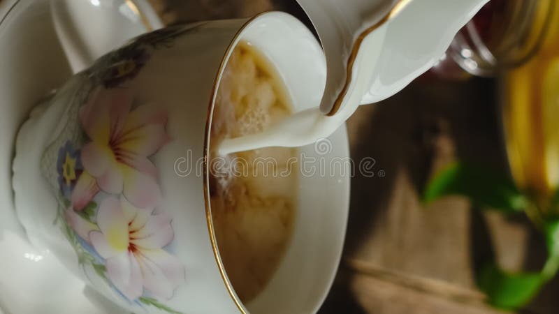 Vertical Video. Pouring Milk into Tea Cup. Tea Party. Stock Footage ...