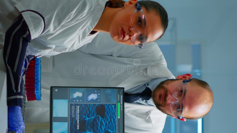 Vertical Video: Team of Scientists Sitting in Laboratory Looking at ...