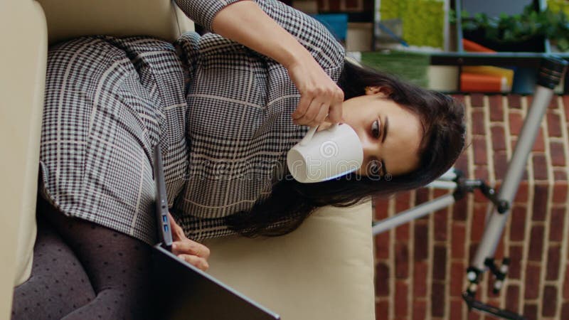 Vertical Video Teleworker Lying on Couch, Drinking Coffee while ...